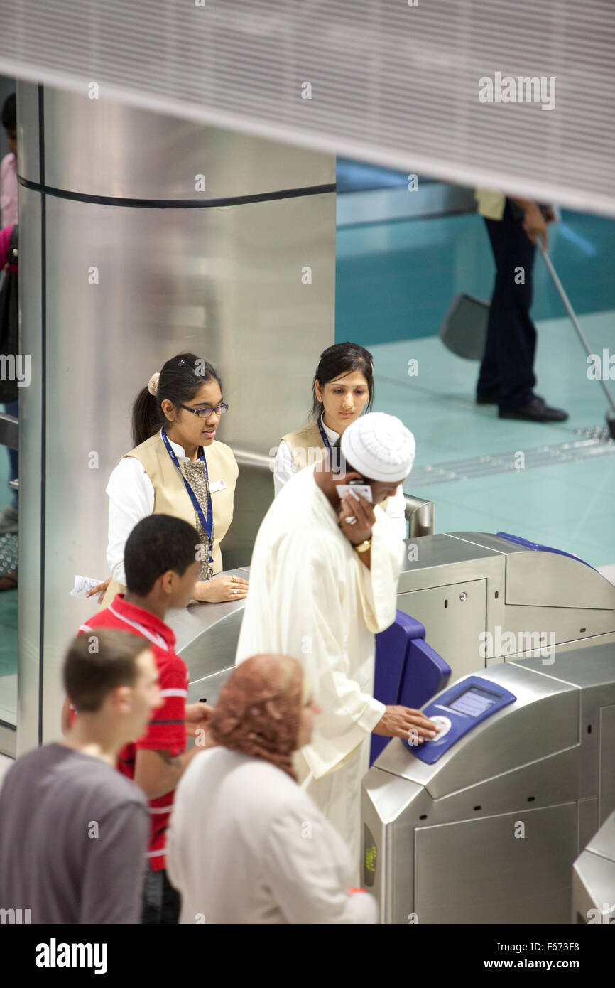 Dubai Metro station staff attending to the public Stock Photo - Alamy