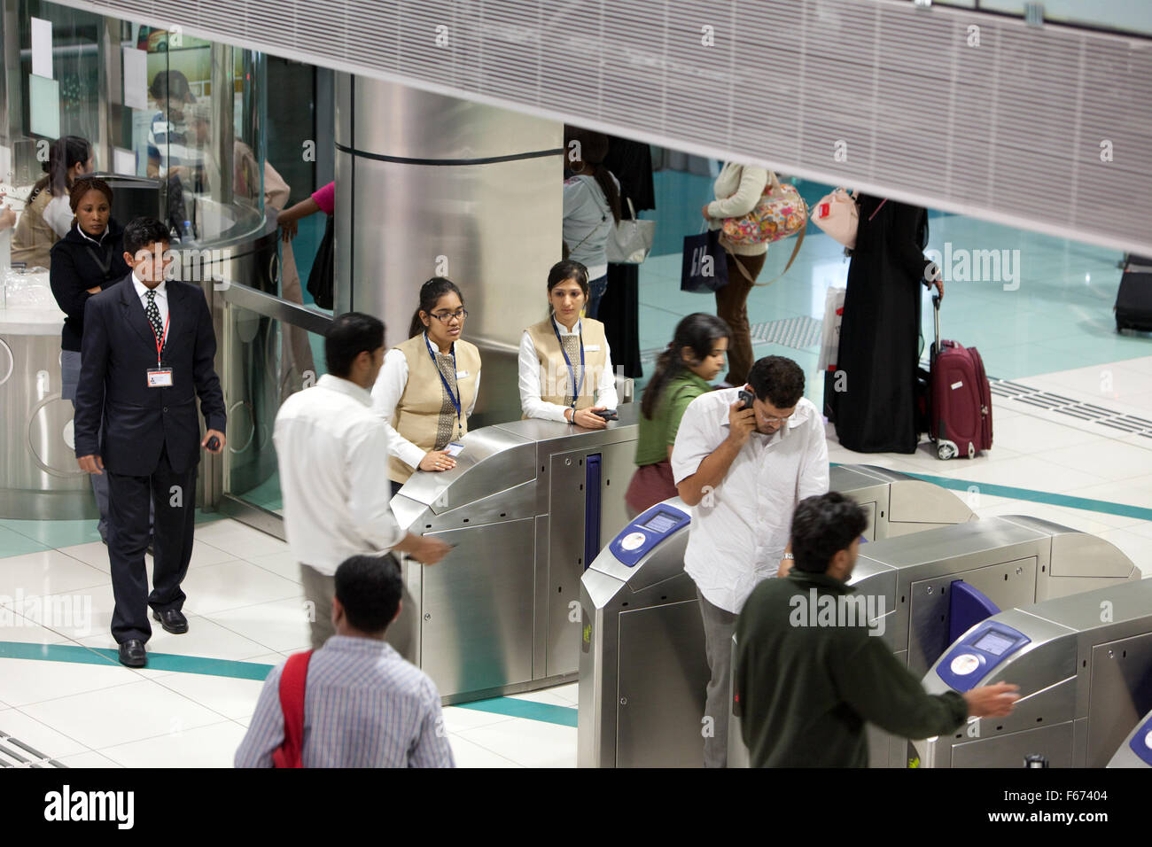 Dubai Metro station staff attending to the public Stock Photo - Alamy