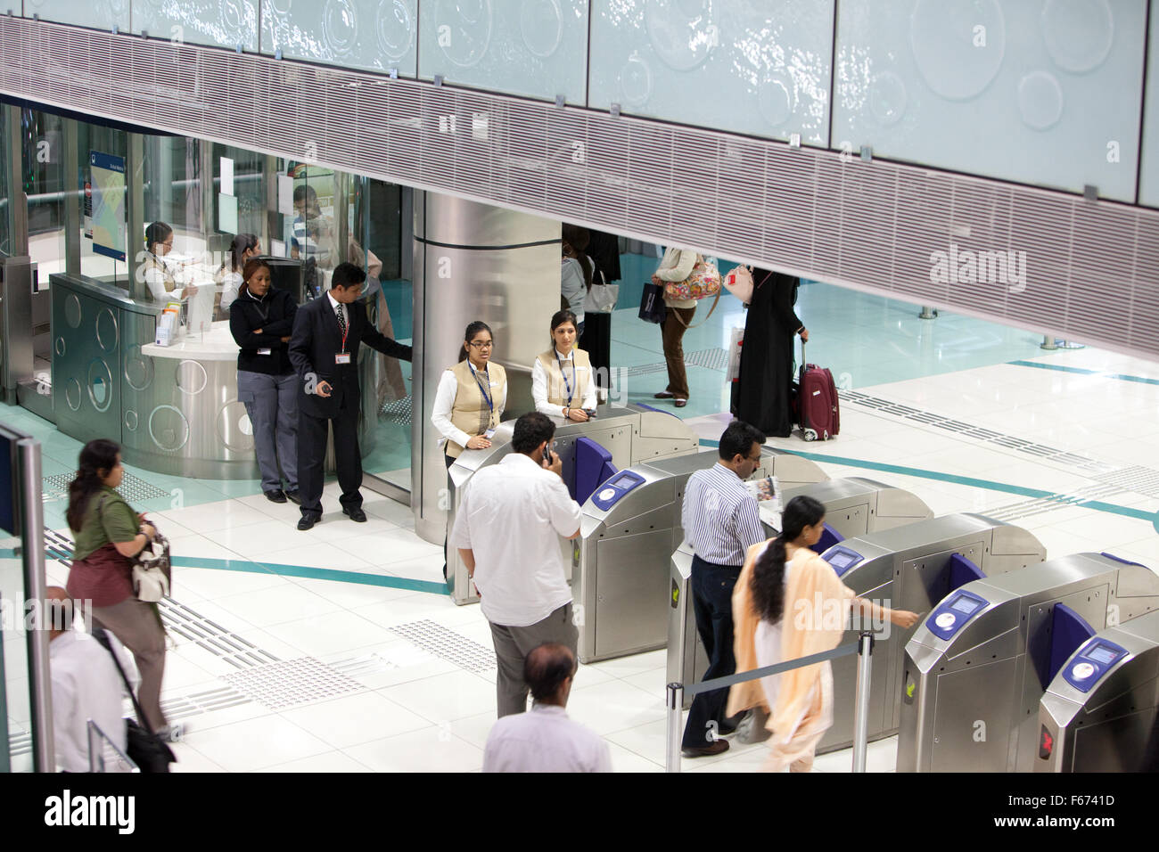 Dubai Metro station staff attending to the public Stock Photo - Alamy