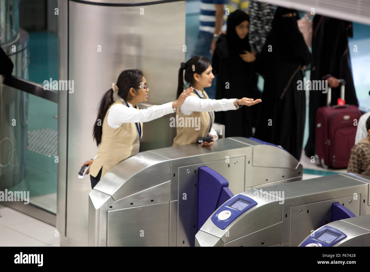 Dubai Metro station staff attending to the public Stock Photo - Alamy