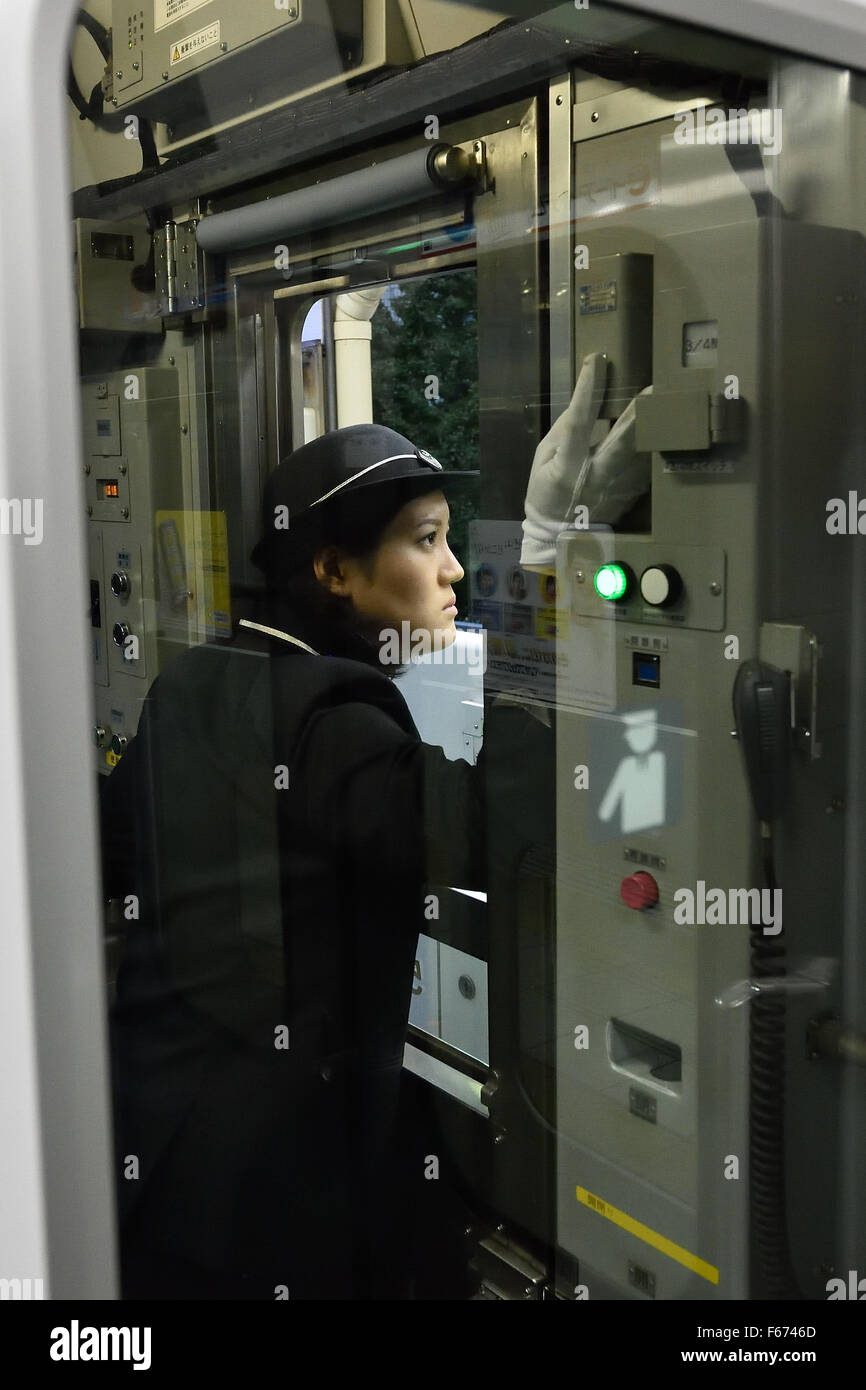 Tokyo, Japan. 13th Nov, 2015. A female Japanese train conductor has ...