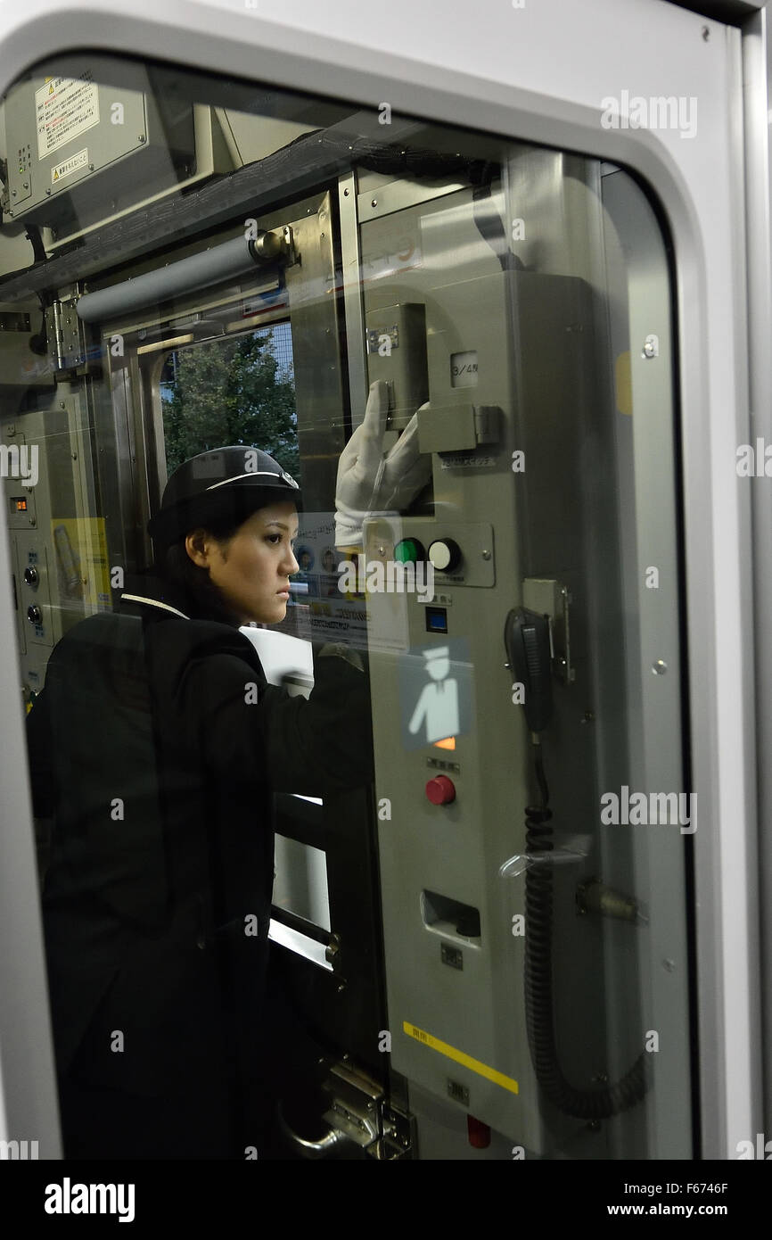 Tokyo, Japan. 13th Nov, 2015. A female Japanese train conductor has ...