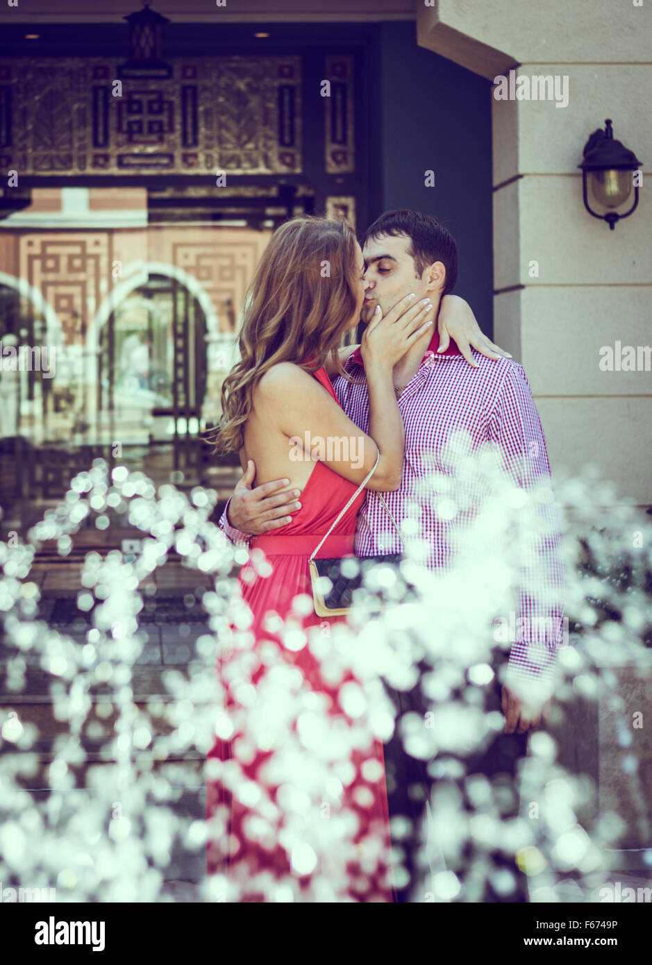 enamored couple posing behind the fountain Stock Photo - Alamy