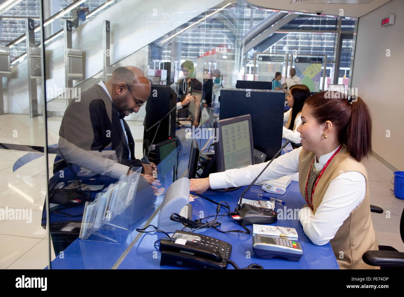 Ticket sales office staff in the Dubai Metro Stock Photo - Alamy