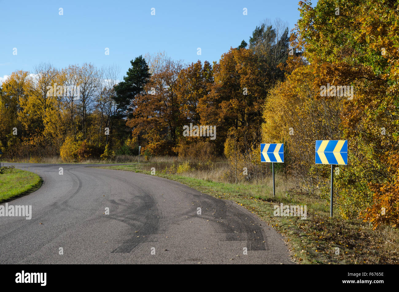 Roadsigns with arrows at roadside in a colorful landscape at fall Stock ...