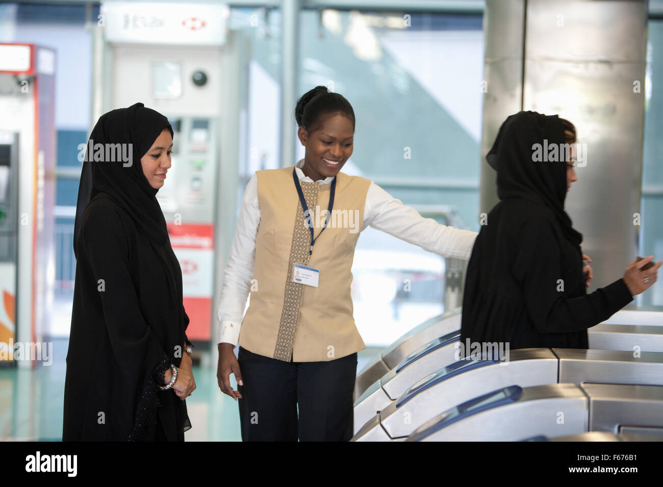 Staff of the Dubai Metro assisting the public Stock Photo - Alamy