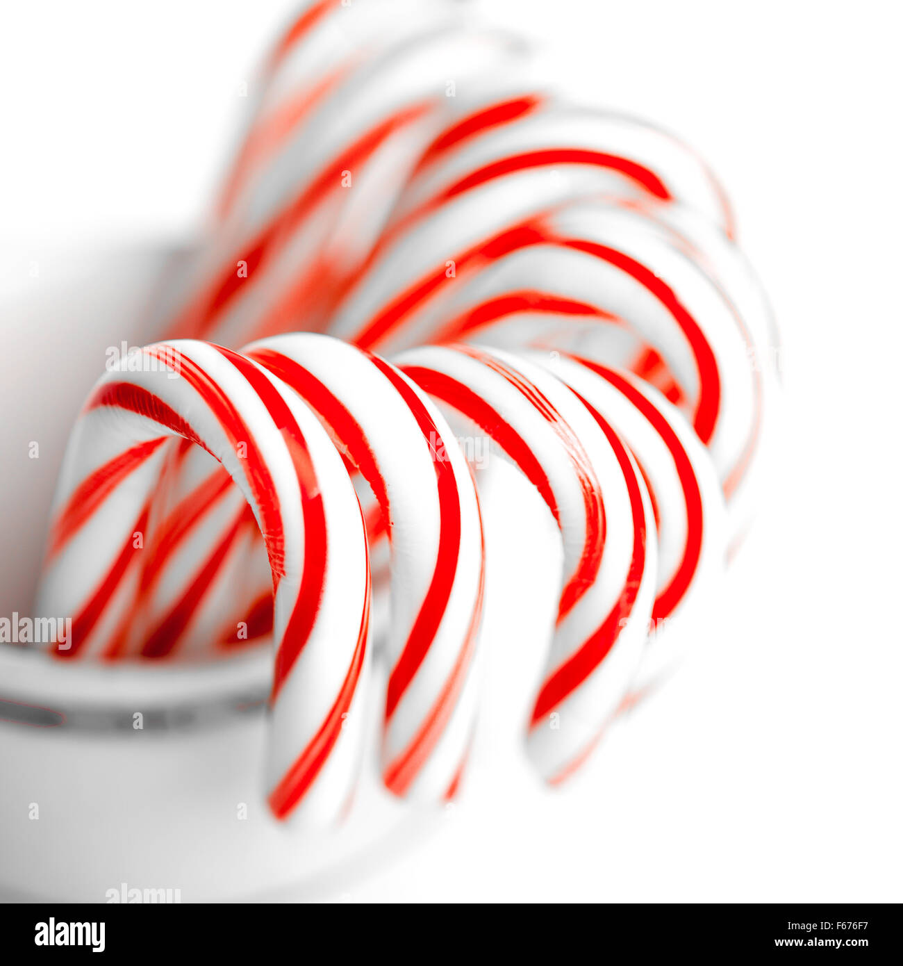 White and red peppermint candy canes in bucket Stock Photo - Alamy