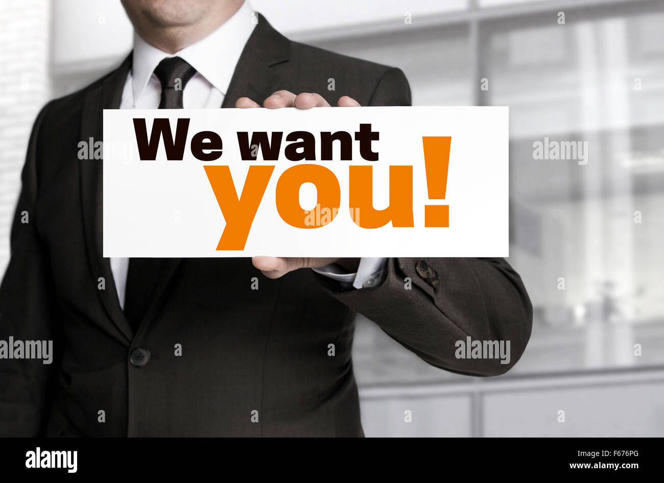 We want you; sign is held by businessman concept Stock Photo - Alamy