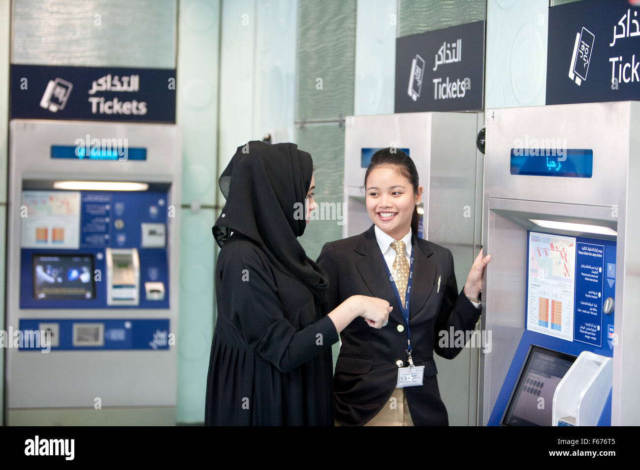 Staff of the Dubai Metro assisting the public Stock Photo - Alamy