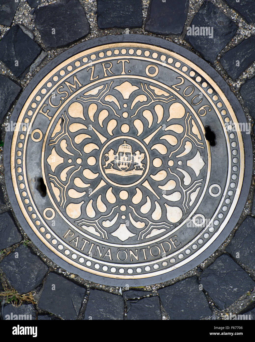 Round beautiful metal manhole cover in Budapest Stock Photo - Alamy