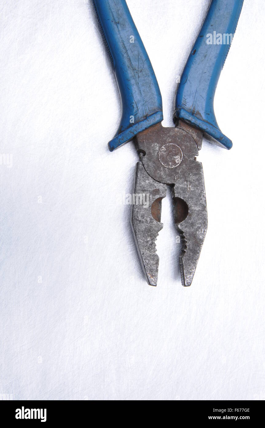 Old pliers on grey metal background with place on text Stock Photo - Alamy