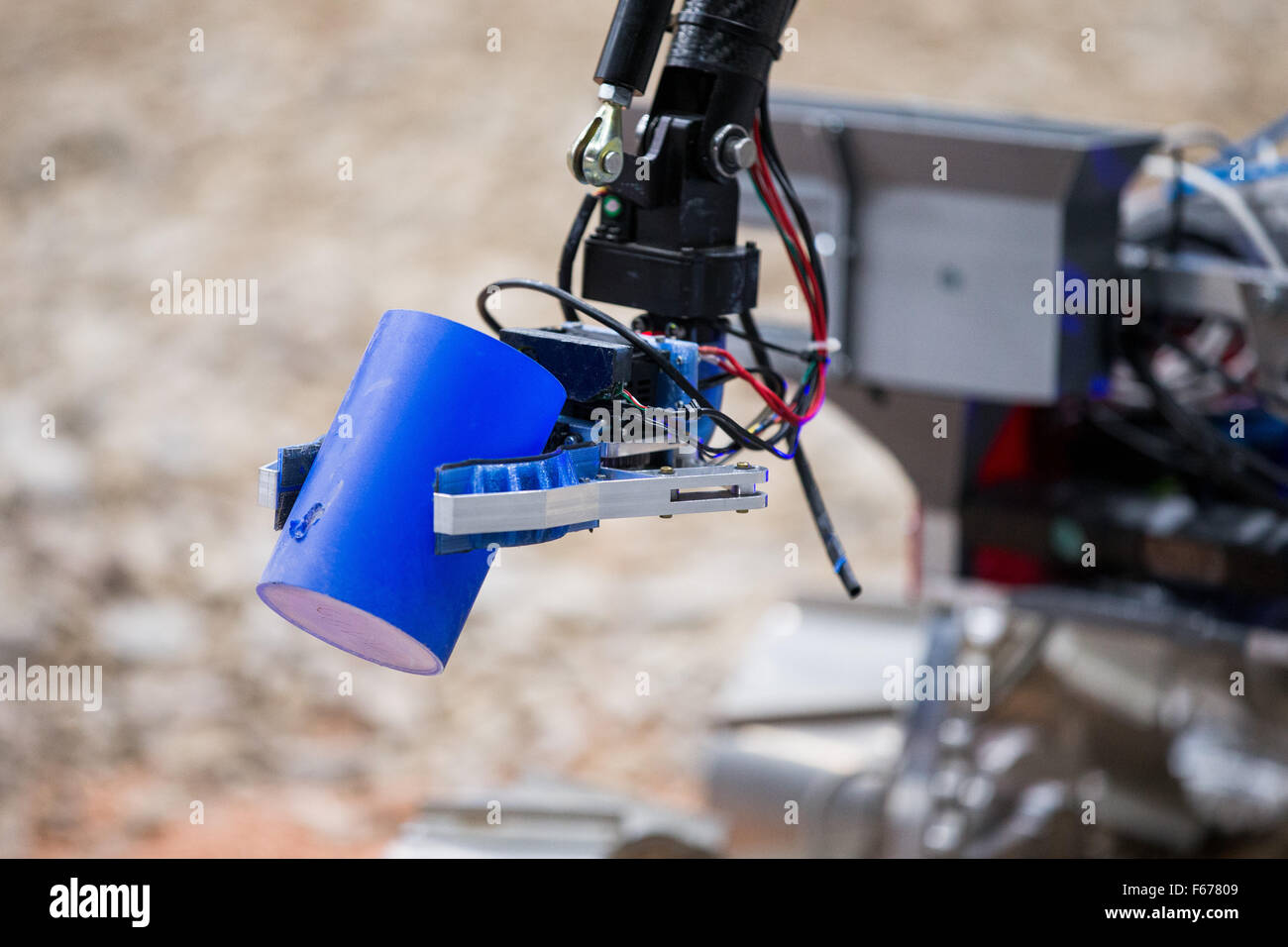 Robot 'SEAR' (TU Berlin) picks up an object on a course of rubble and ...
