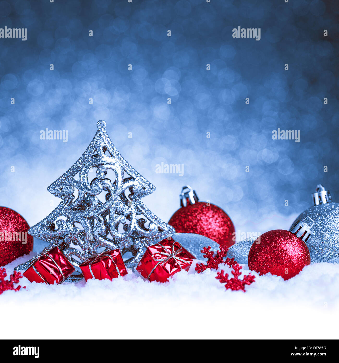 christmas ornament in snow on glitter background Stock Photo - Alamy