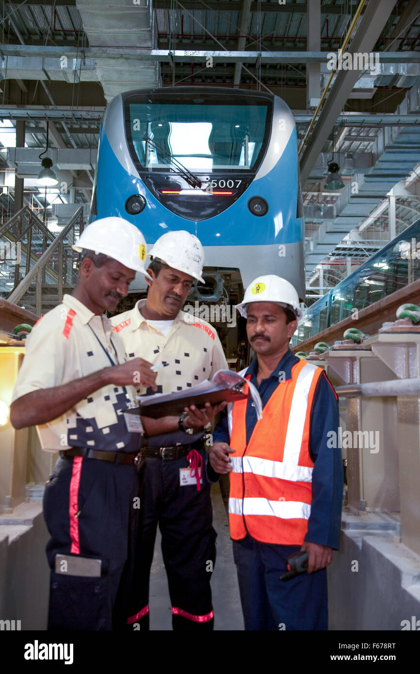 Engineers working under tube train in Dubai Metro Stock Photo - Alamy
