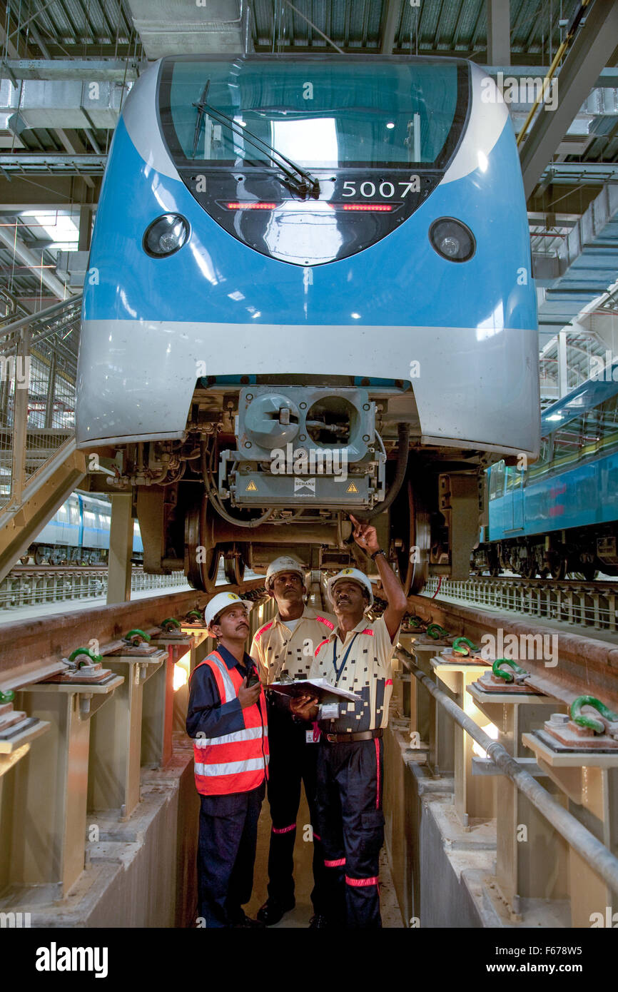 Engineers working under tube train in Dubai Metro Stock Photo - Alamy