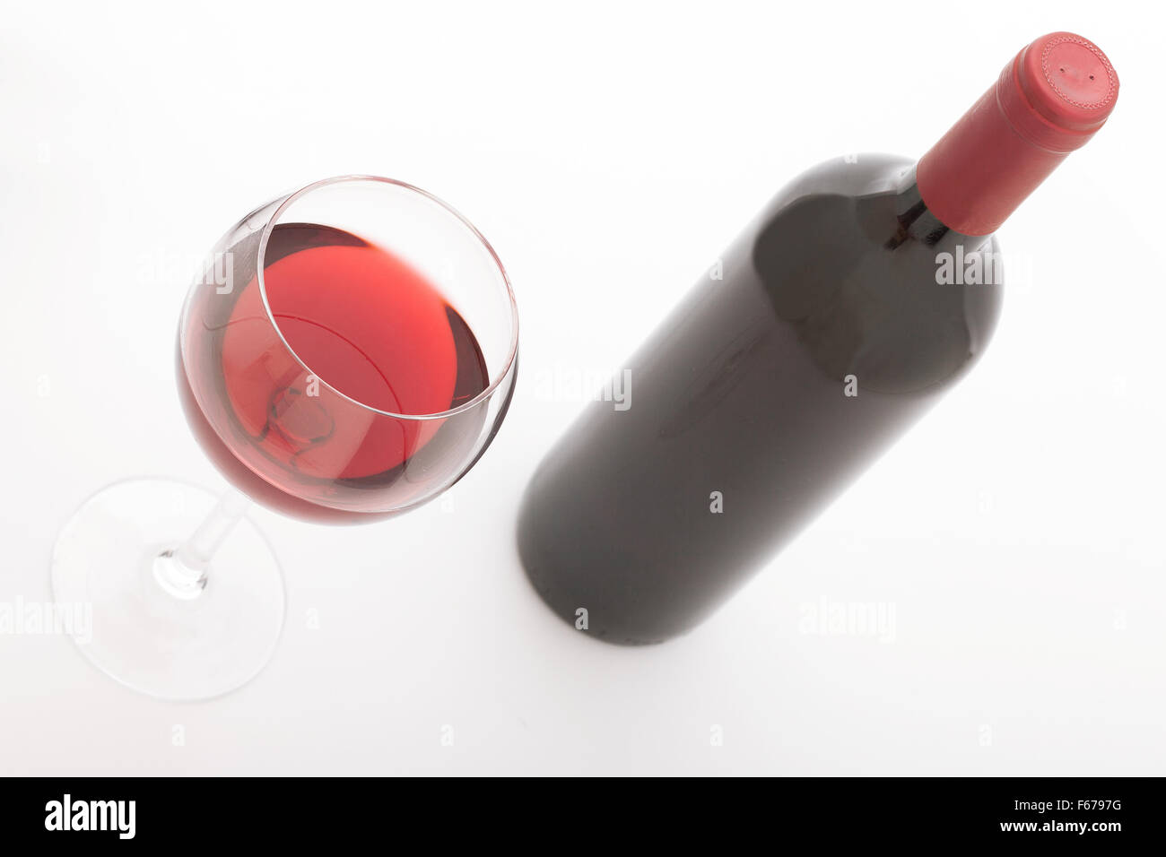 Glass and bottle of red wine. Top view unusually on white background Stock Photo - Alamy
