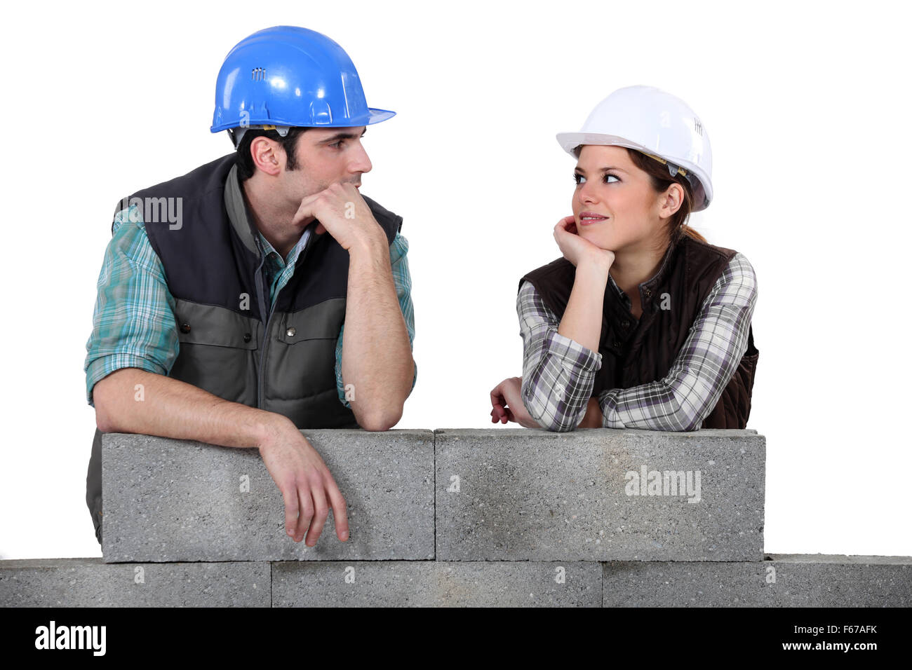 Builders leaning on an unfinished wall Stock Photo - Alamy