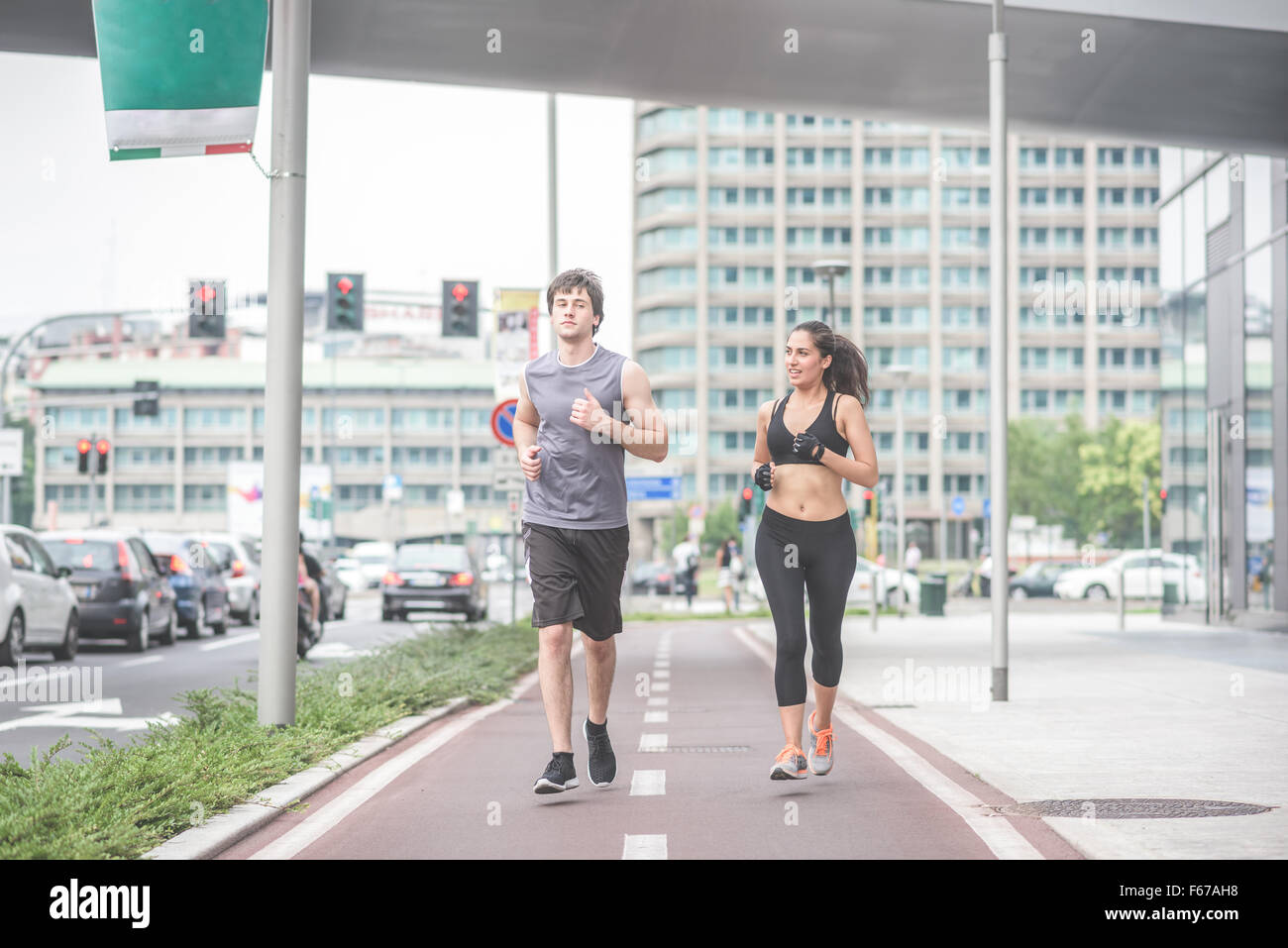 Couple of young handsome caucasian man and woman running into the ...