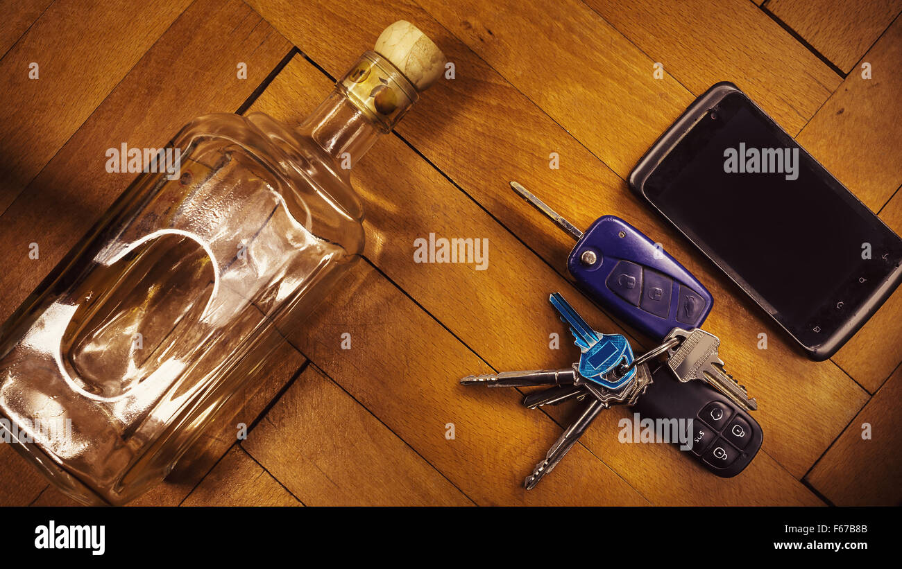 Conceptual composition about driving and drinking, empty spirit bottle ...