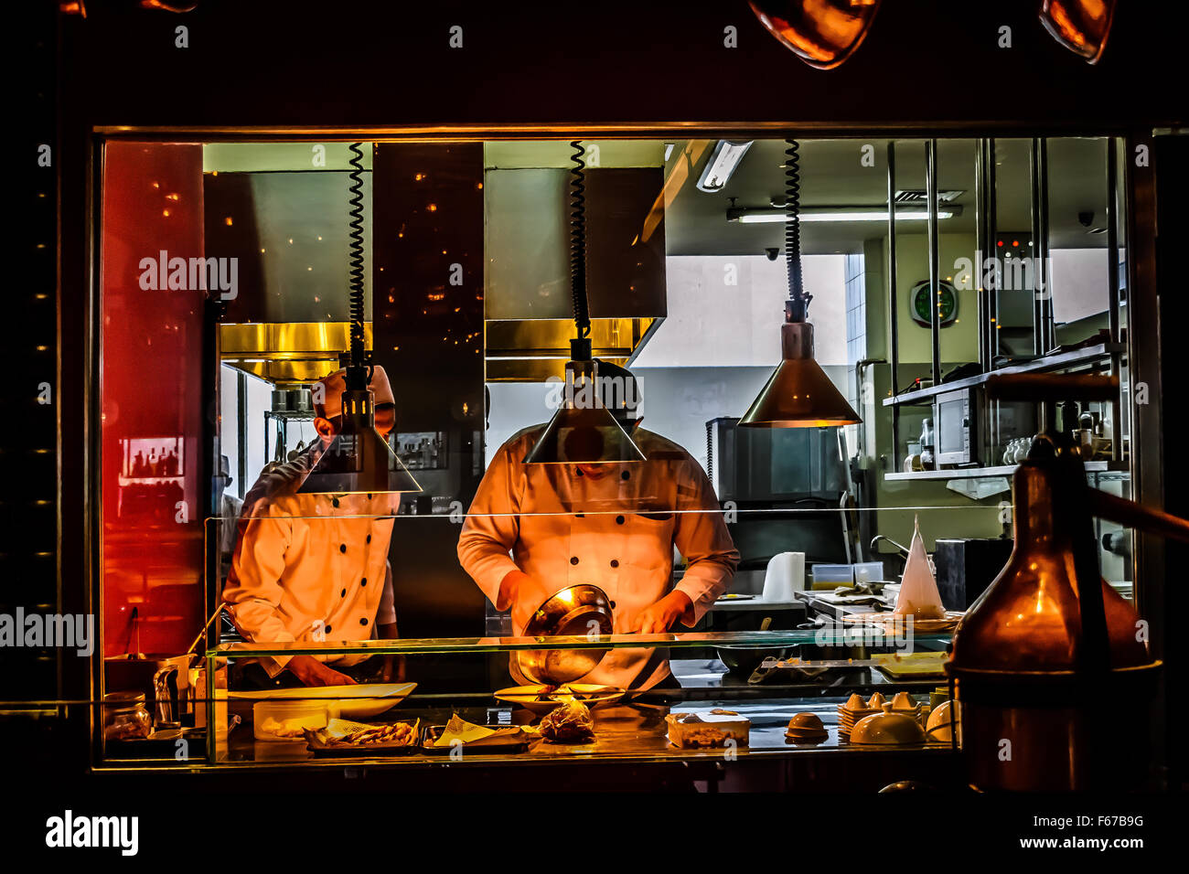 Chefs working in italian restaurant kitchen Stock Photo - Alamy
