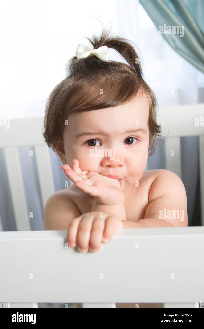 Infant baby resting and playing in his little baby bed Stock Photo - Alamy