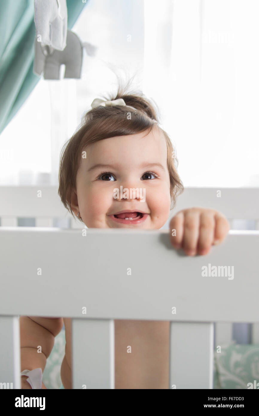 Infant baby resting and playing in his little baby bed Stock Photo - Alamy