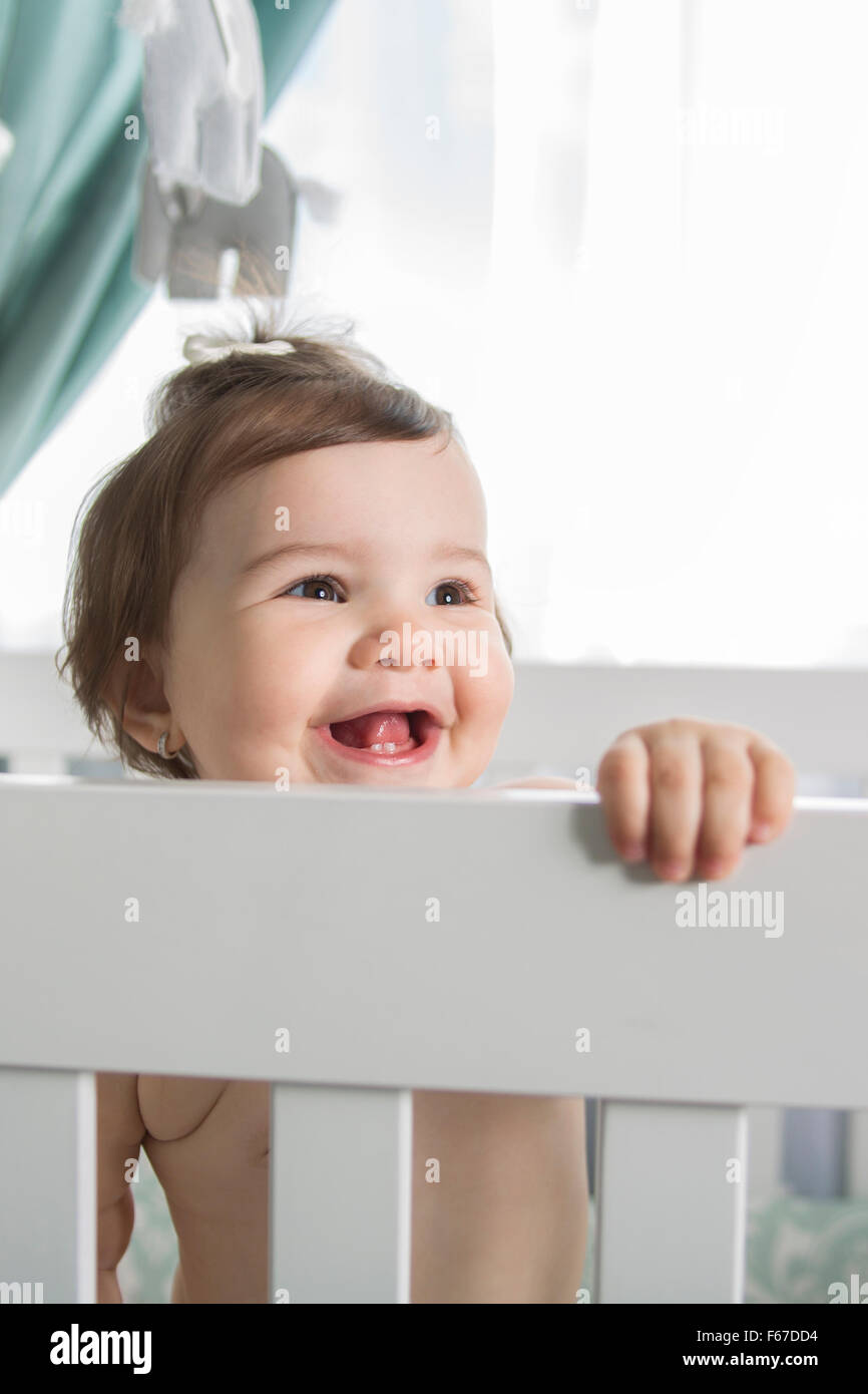 Infant baby resting and playing in his little baby bed Stock Photo - Alamy
