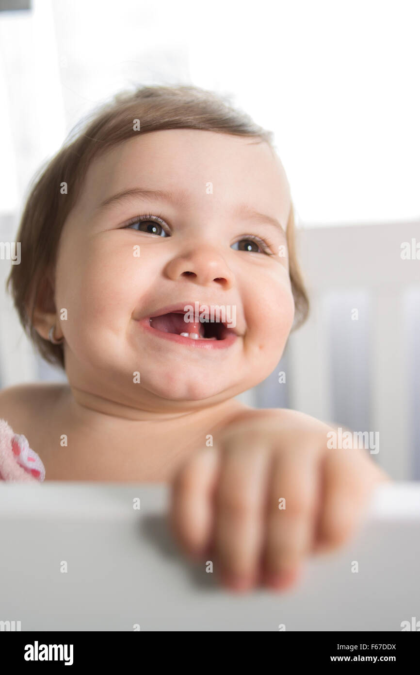 Infant baby resting and playing in his little baby bed Stock Photo - Alamy