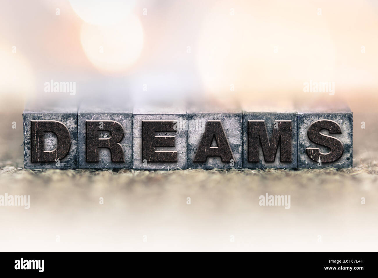 The word "DREAMS" written in vintage ink stained letterpress type Stock ...