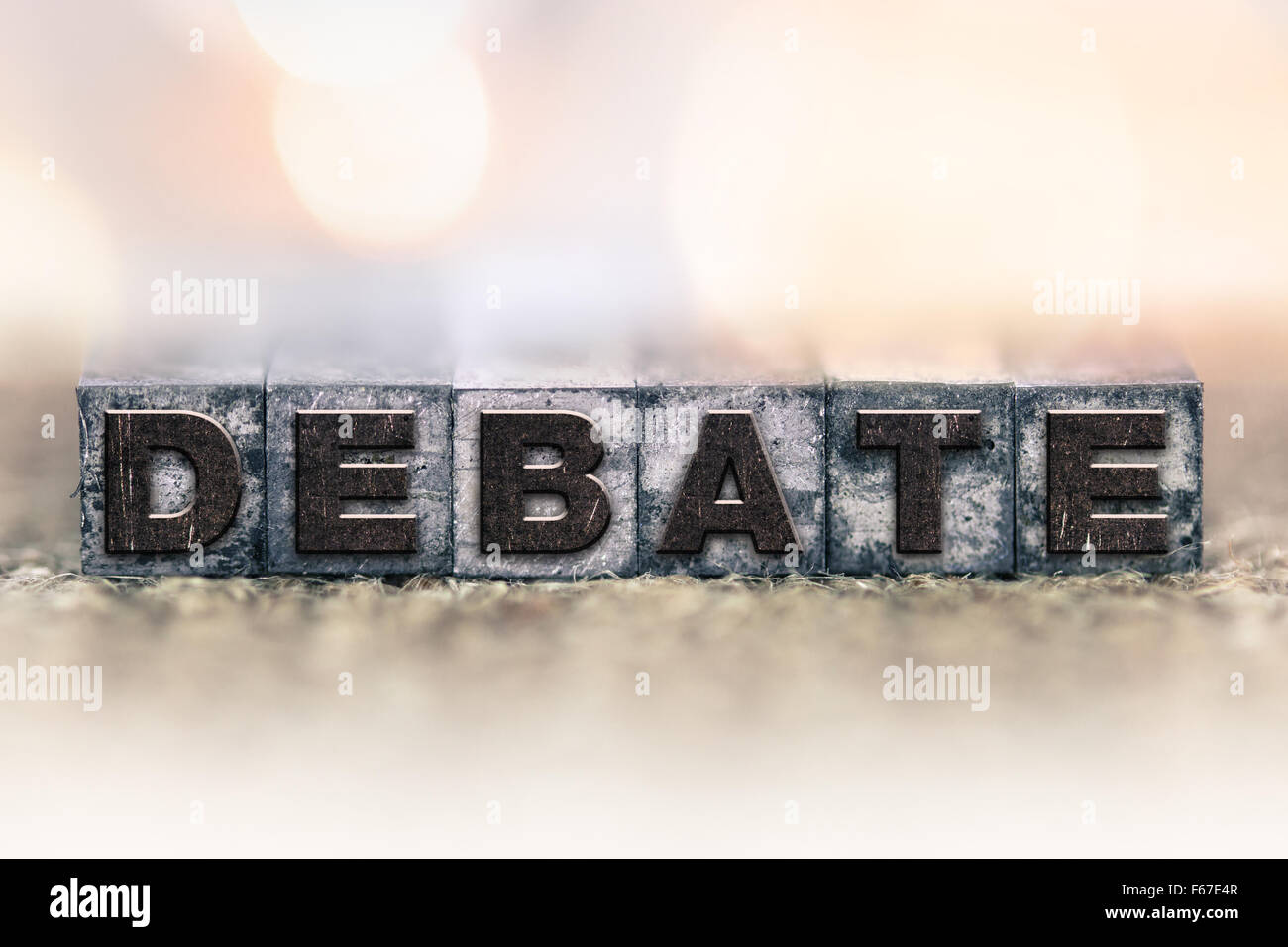 The word "DEBATE" written in vintage ink stained letterpress type Stock ...