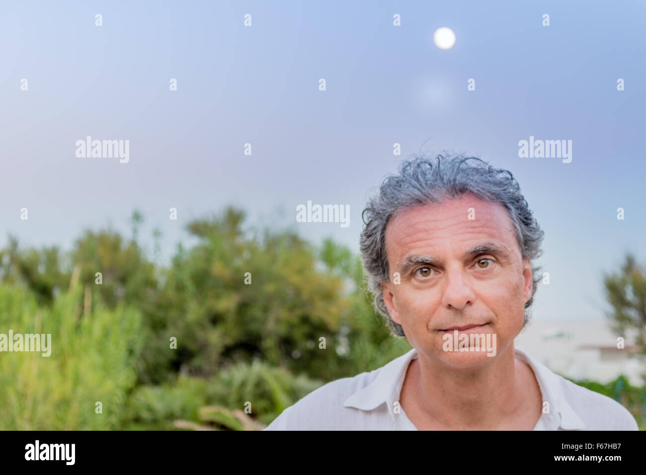 middle-aged man in white shirt while visiting seaside town, Vieste in ...