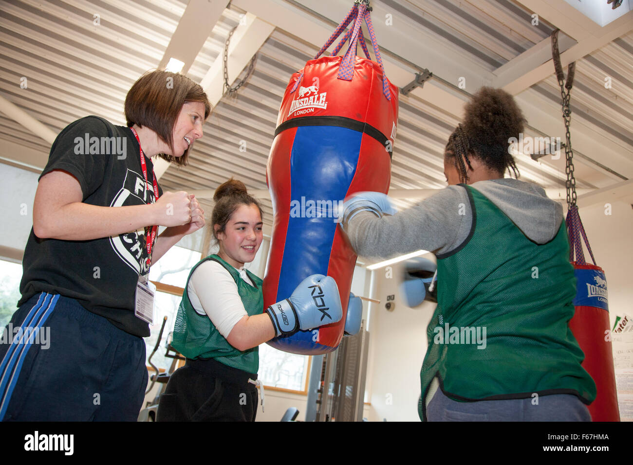 Female teenager students being coached in boxing Stock Photo - Alamy