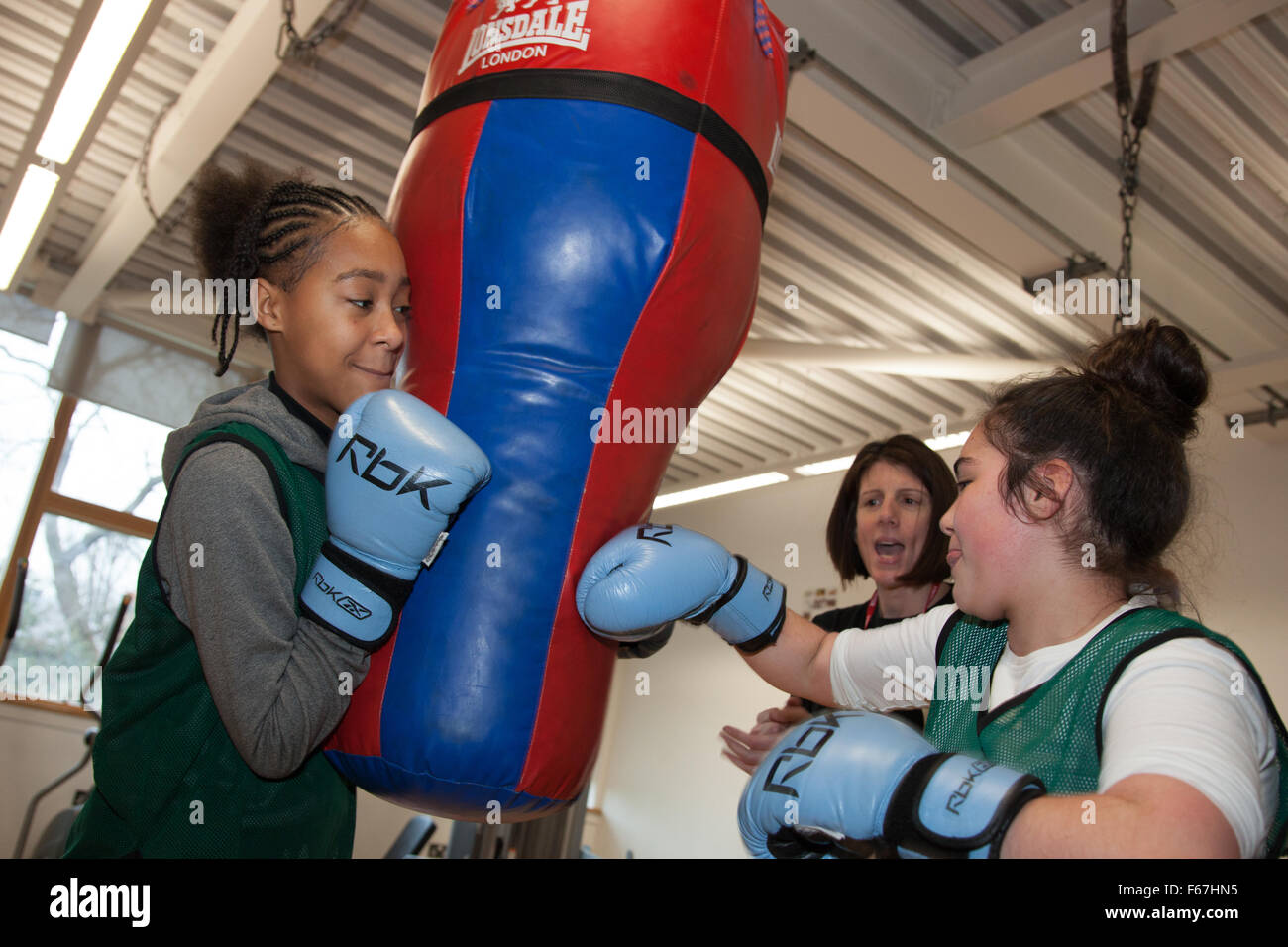 Female teenager students being coached in boxing Stock Photo - Alamy