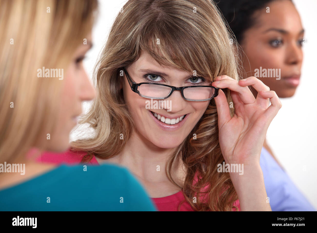 Young woman peering over her glasses Stock Photo - Alamy