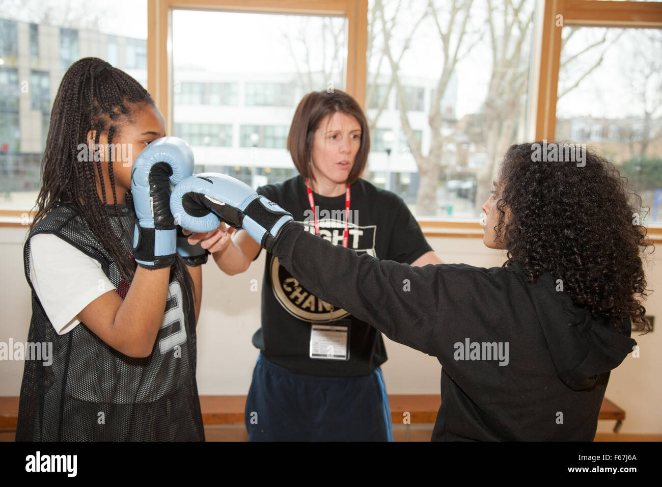 Female teenager students being coached in boxing Stock Photo - Alamy
