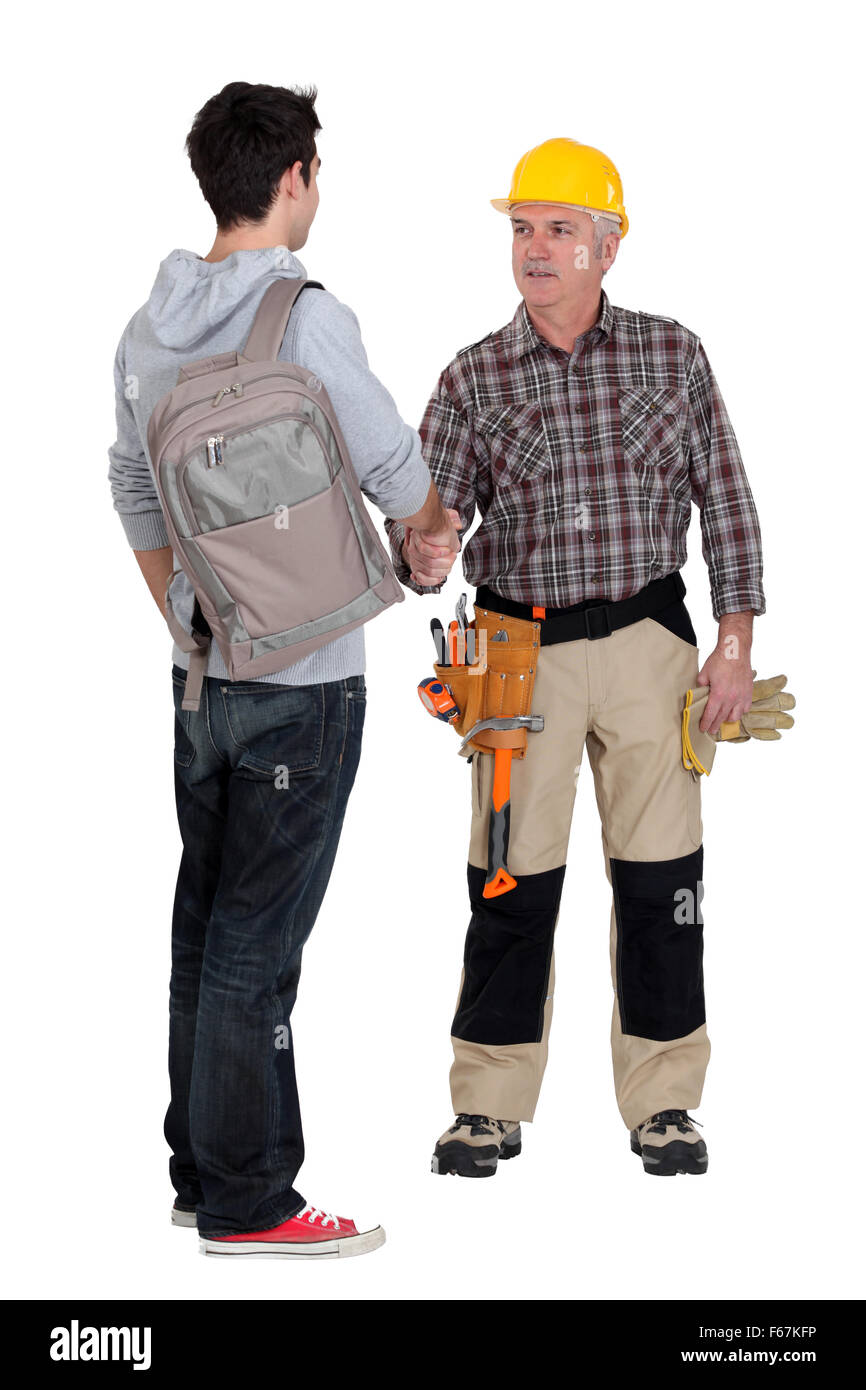 senior craftsman and young apprentice shaking hands Stock Photo - Alamy