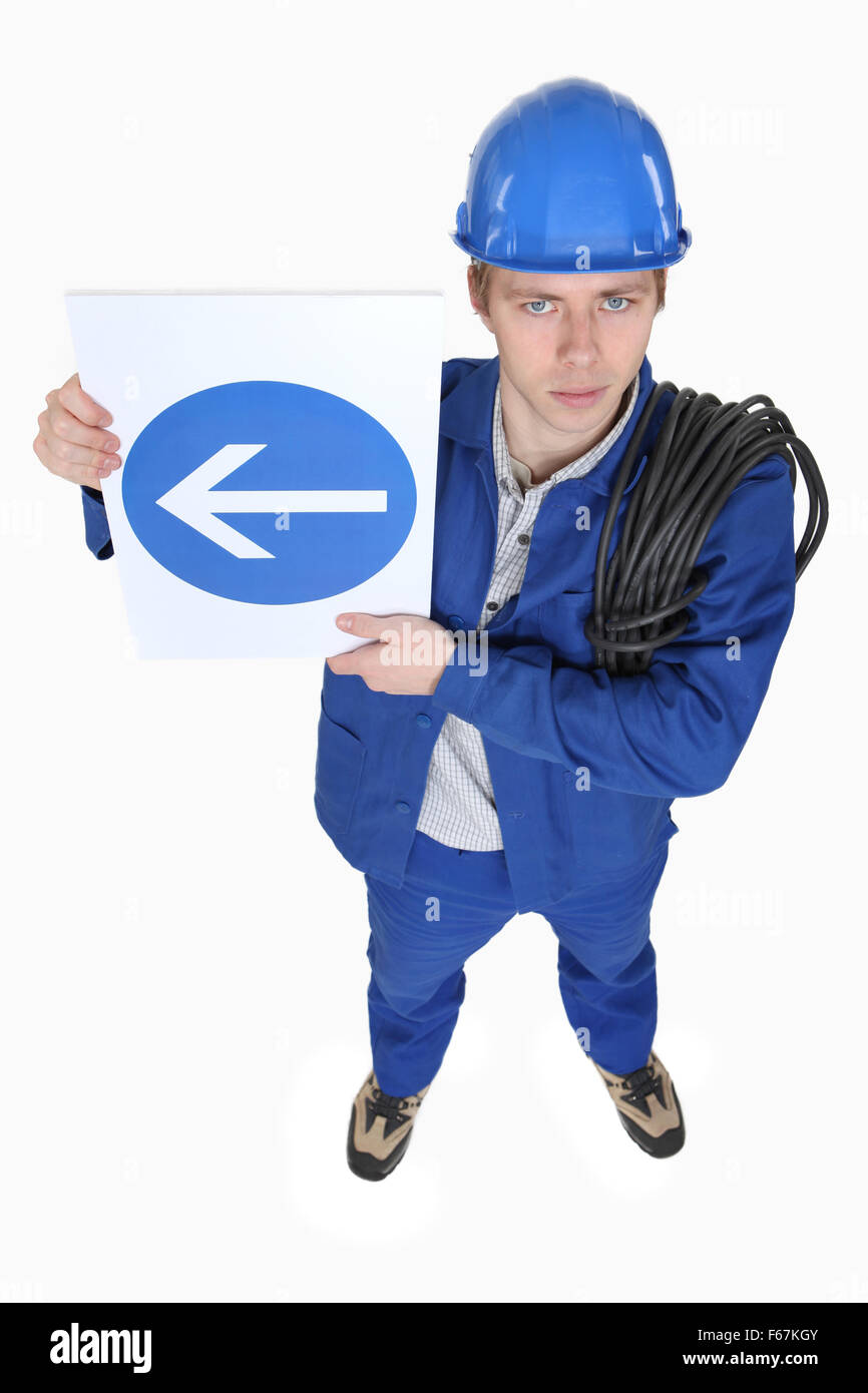 Worker with a one way sign Stock Photo - Alamy