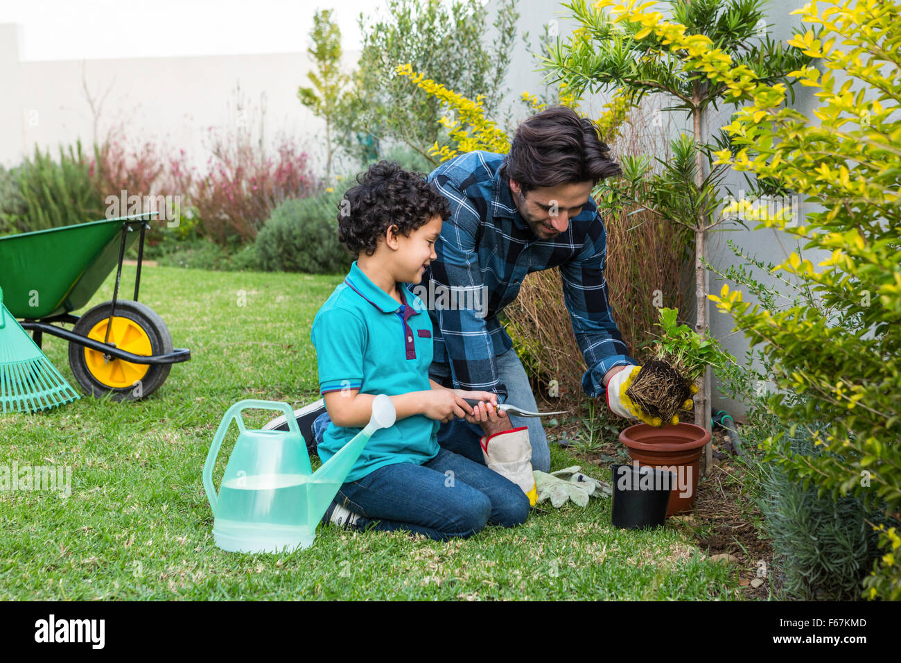 Smiling father and son gardening Stock Photo - Alamy