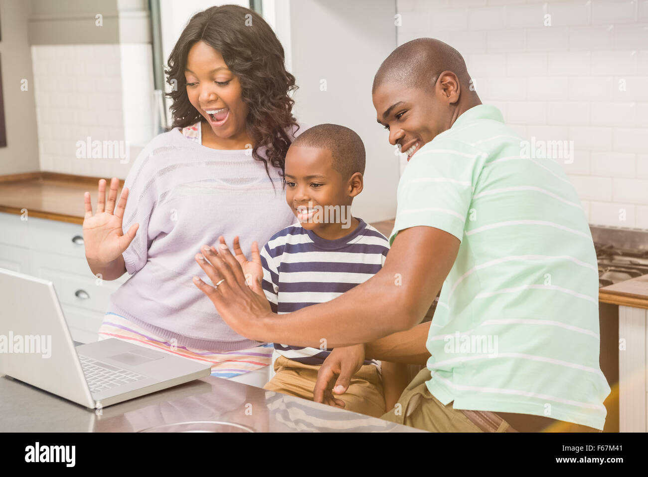 Happy family using laptop Stock Photo - Alamy