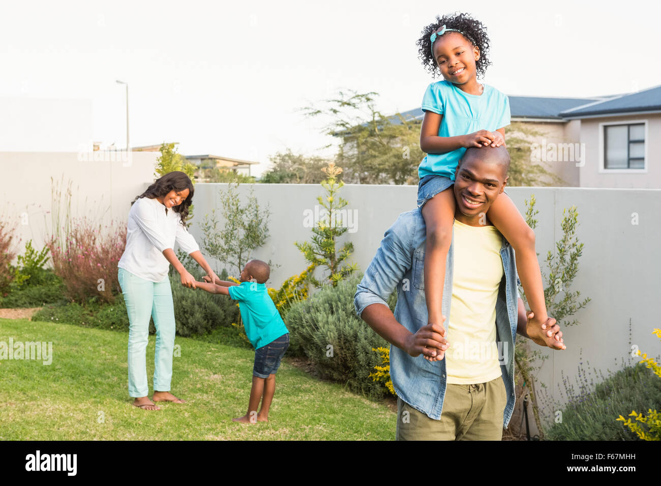 Family having fun in the garden Stock Photo - Alamy