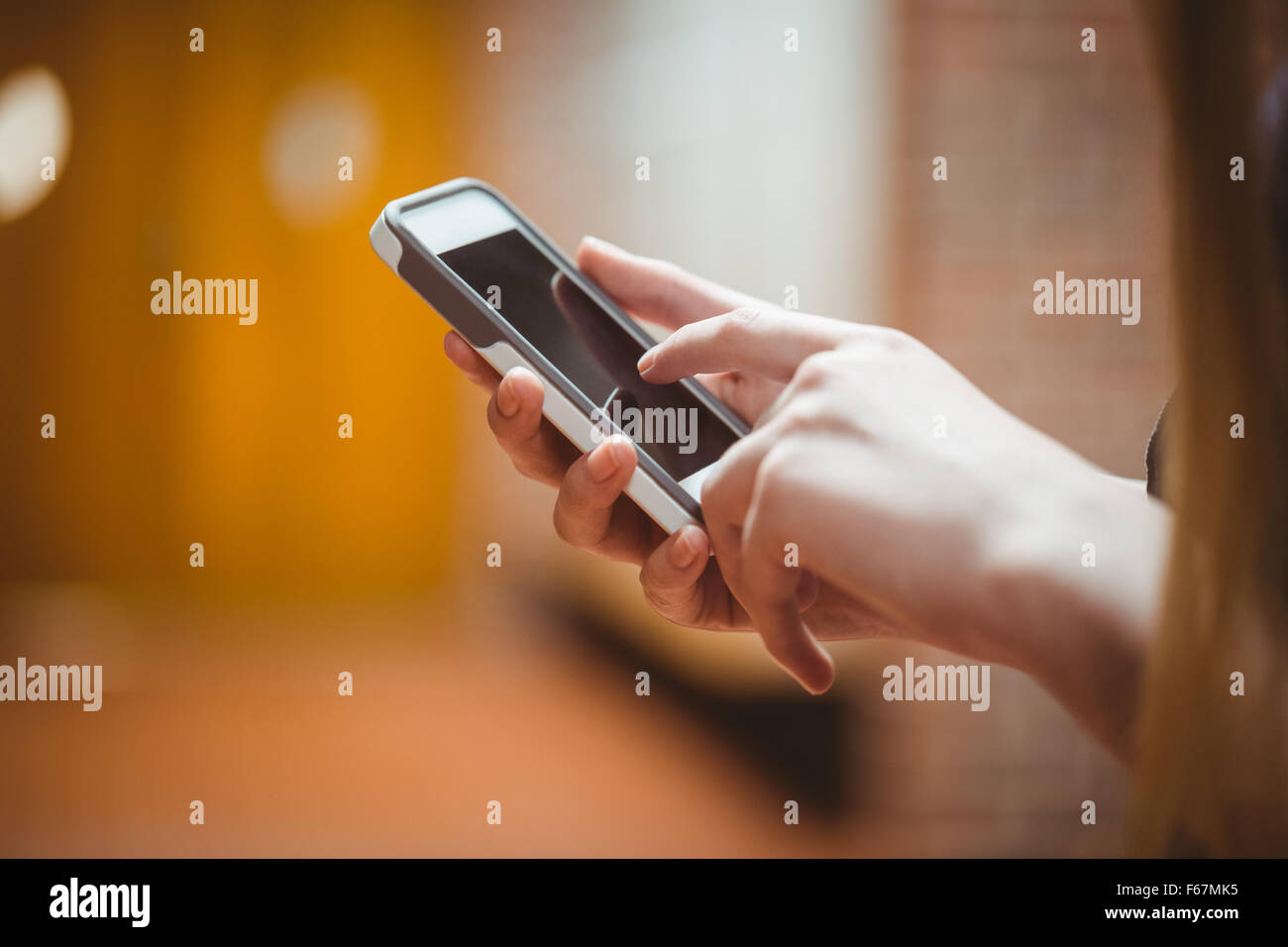 Standing student using smartphone Stock Photo - Alamy