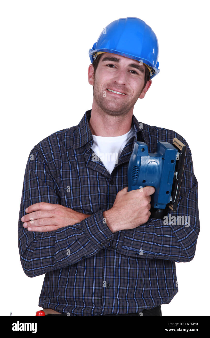 Man holding electric sander Stock Photo - Alamy
