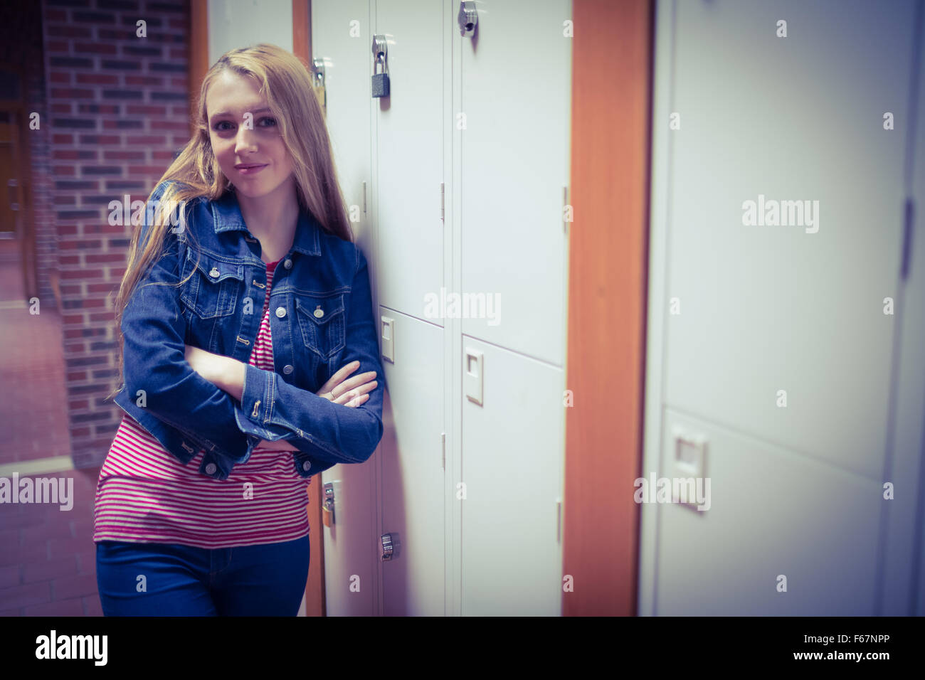 Smiling student leaning against the locker Stock Photo - Alamy