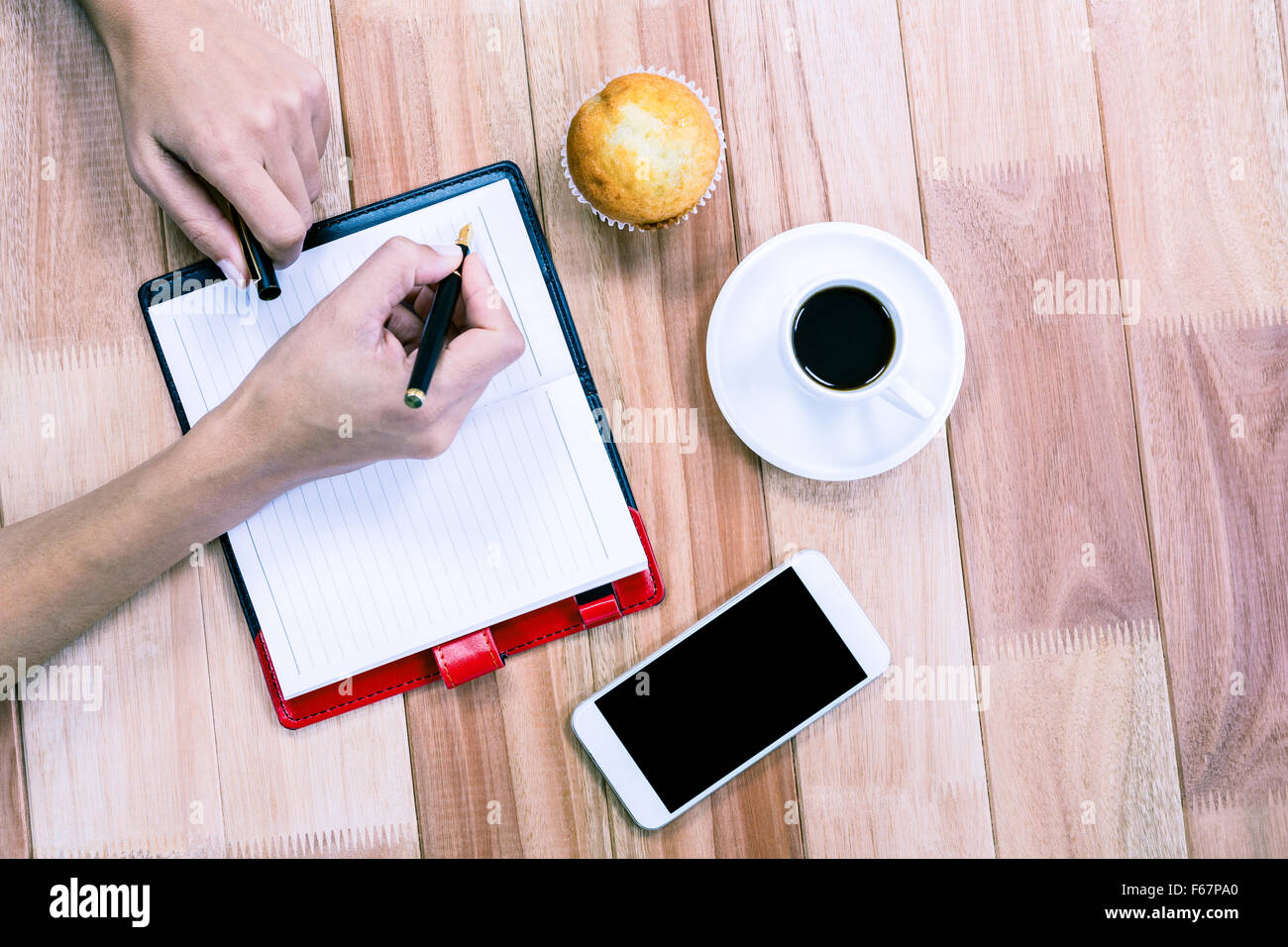 Overhead of feminine hands writing on agenda Stock Photo - Alamy