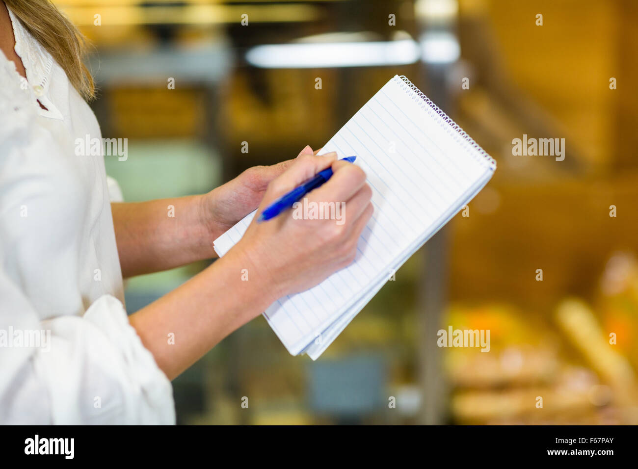 Woman checking list at supermarket Stock Photo - Alamy