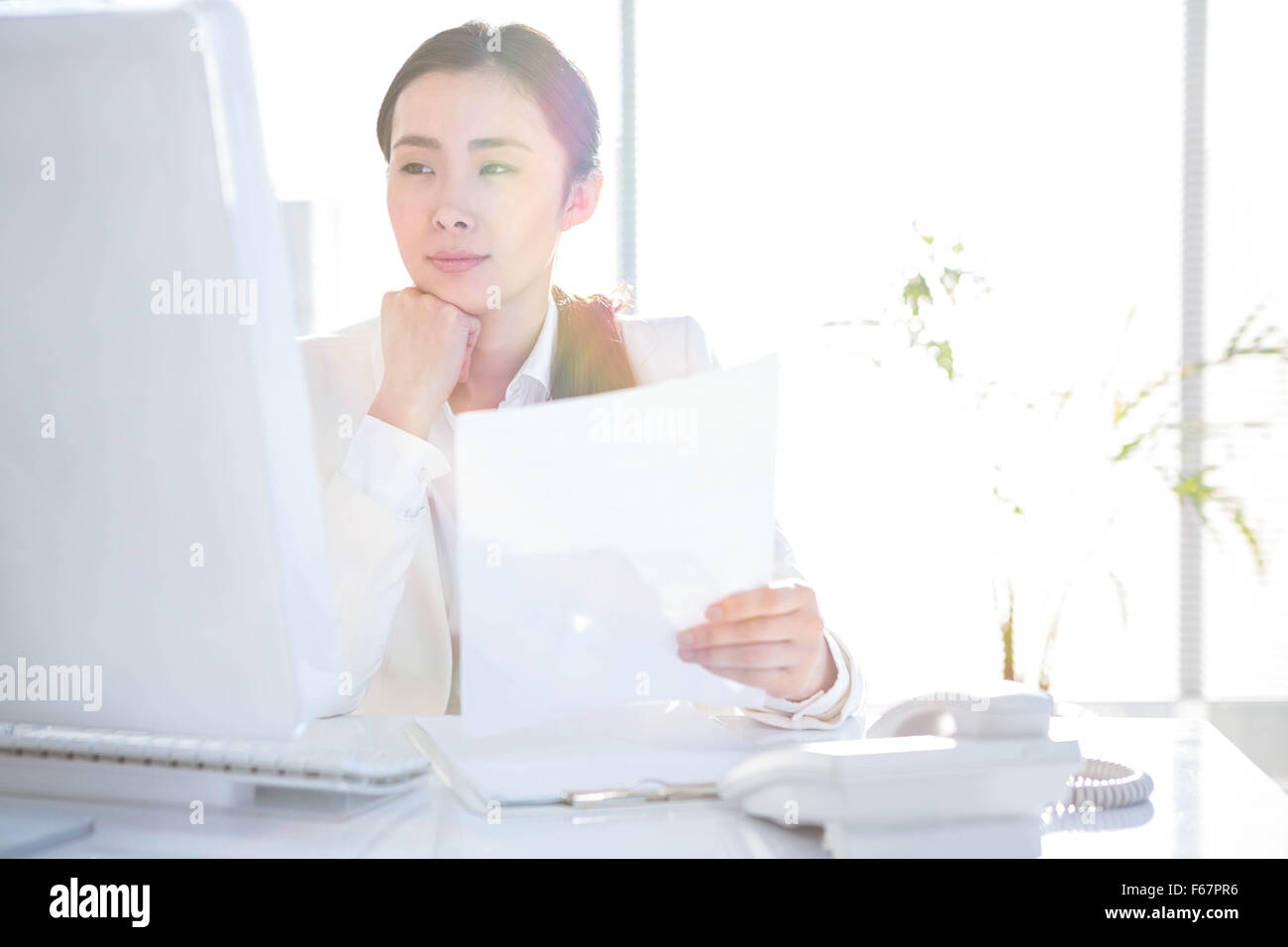 Smiling businesswoman using computer Stock Photo - Alamy