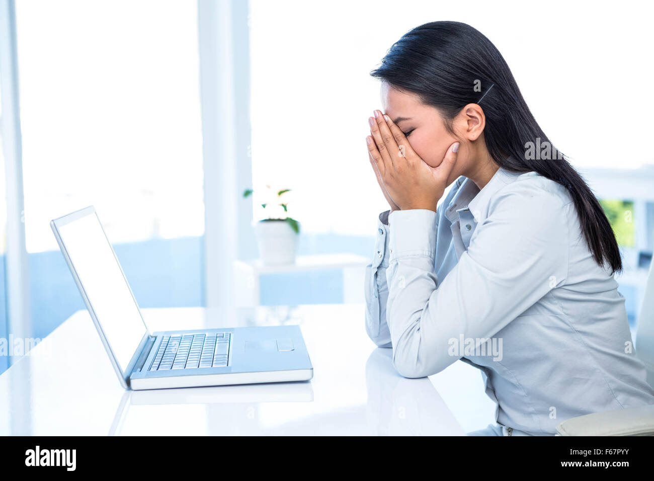 Worried businesswoman covering face Stock Photo - Alamy