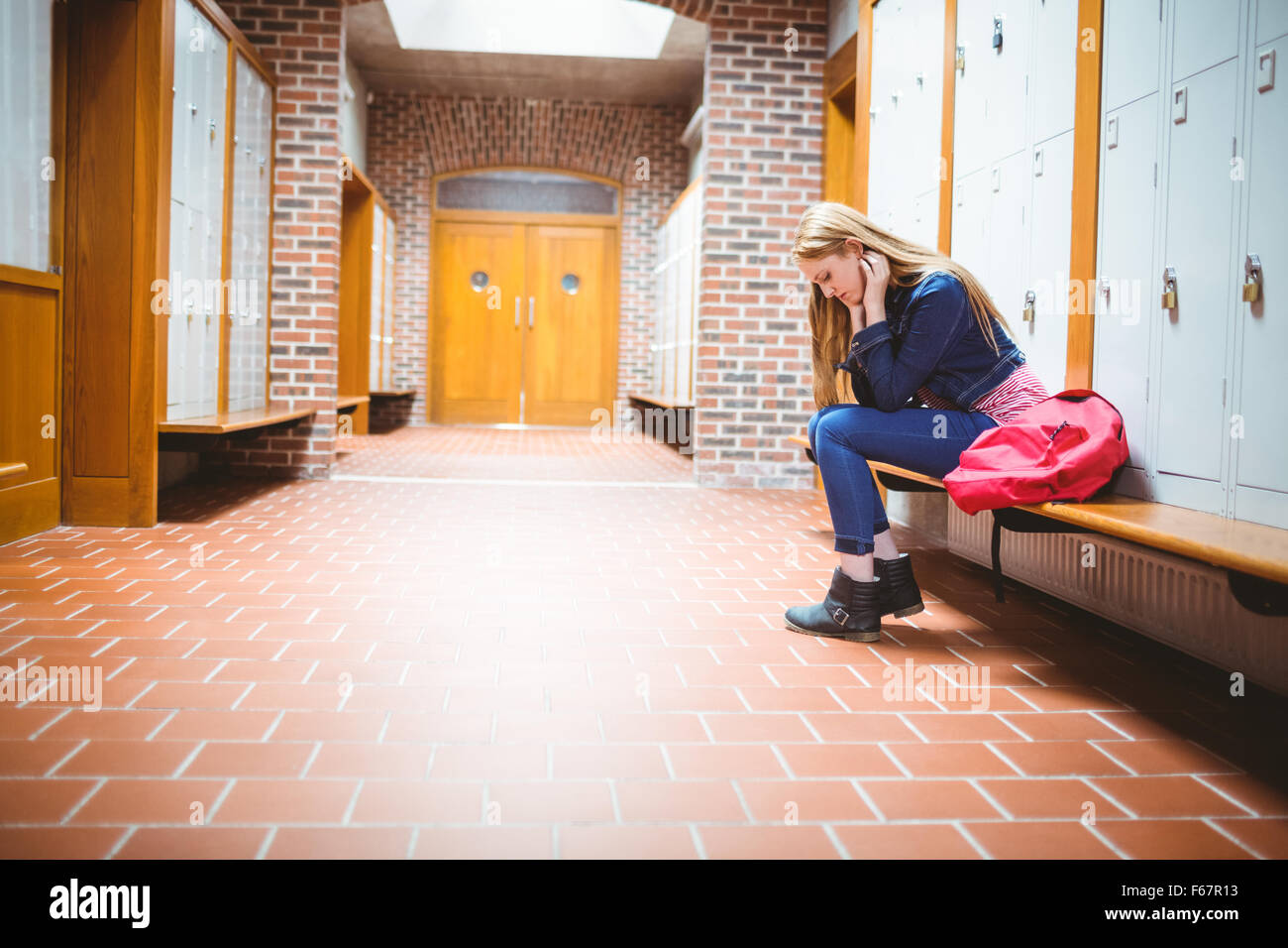 Worried student sitting and looking down Stock Photo - Alamy