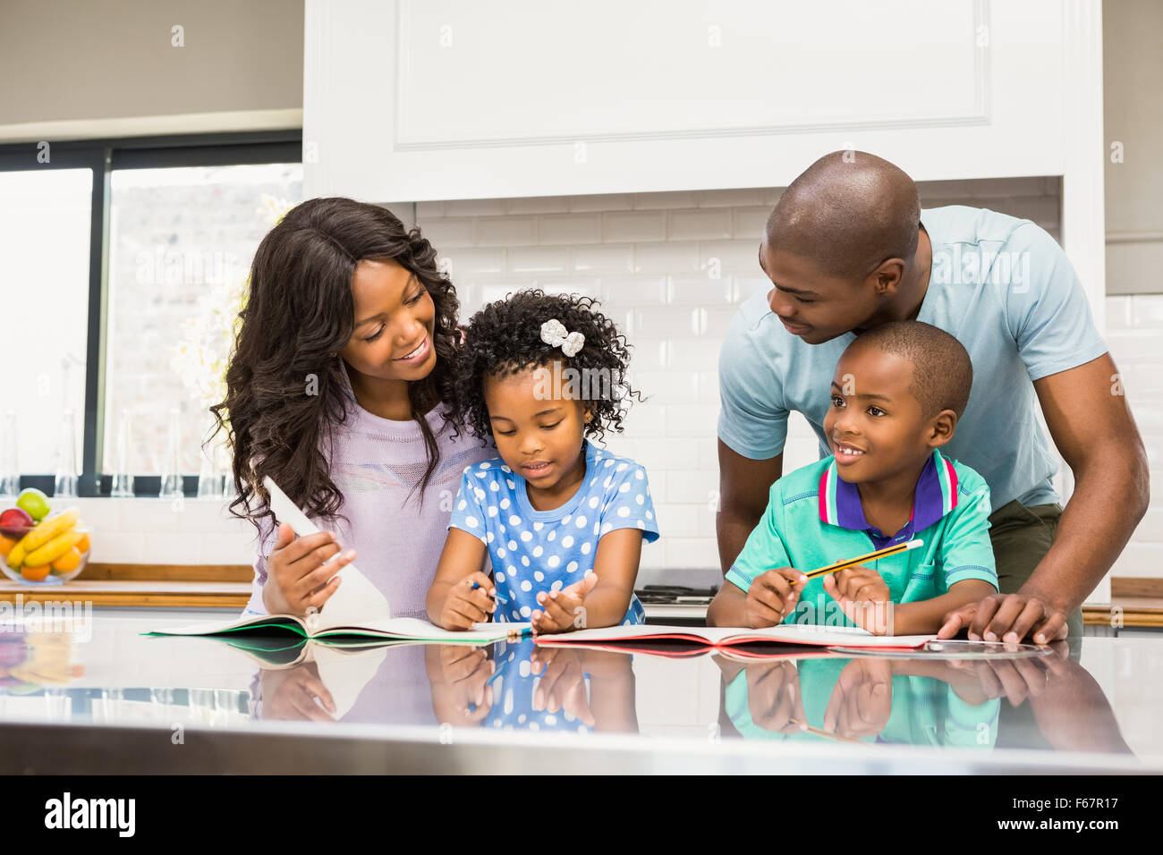 Parents helping children doing homework Stock Photo - Alamy