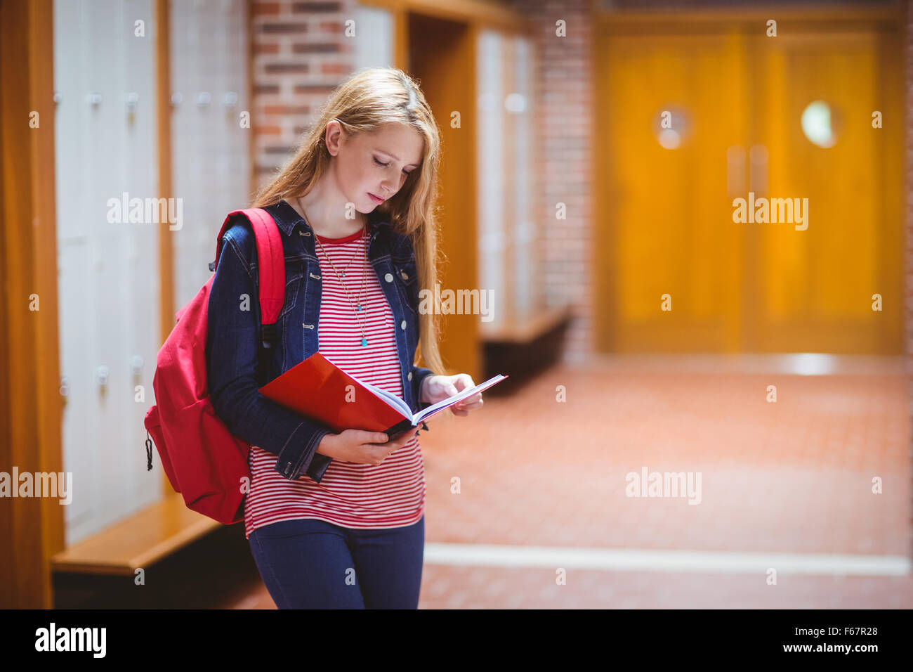 Pretty student with backpack holding notebook Stock Photo - Alamy